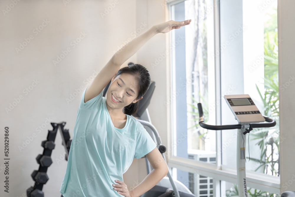 Beautiful and shapely Asian woman working out in the gym, Play exercise ...