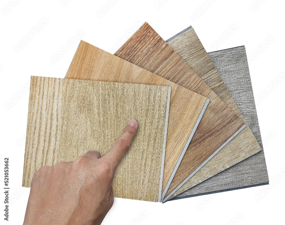 architect's hand selecting modern vinyl flooring tile collection. stack ...