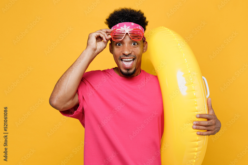 Young smiling happy fun cheerful man 20s he wear pink t-shirt near ...