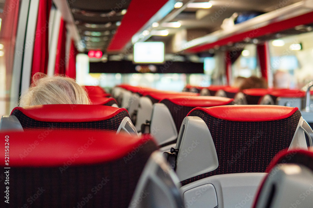Row of seats in a tourist bus and women passenger. Selective focus ...