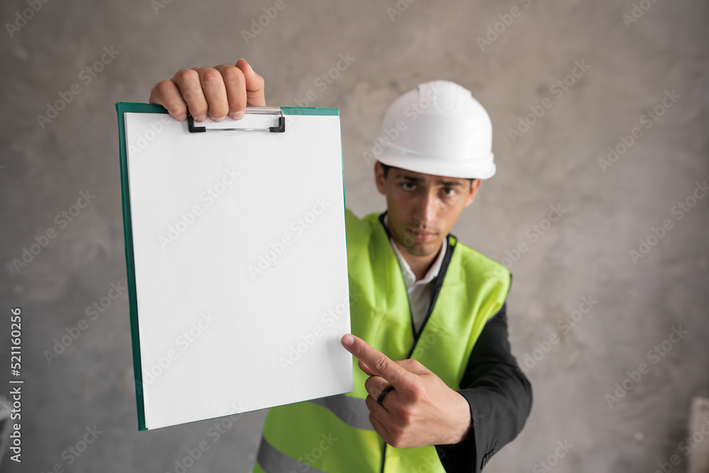 Angry arabic man engineer or architect wearing a hard hat pointing at ...