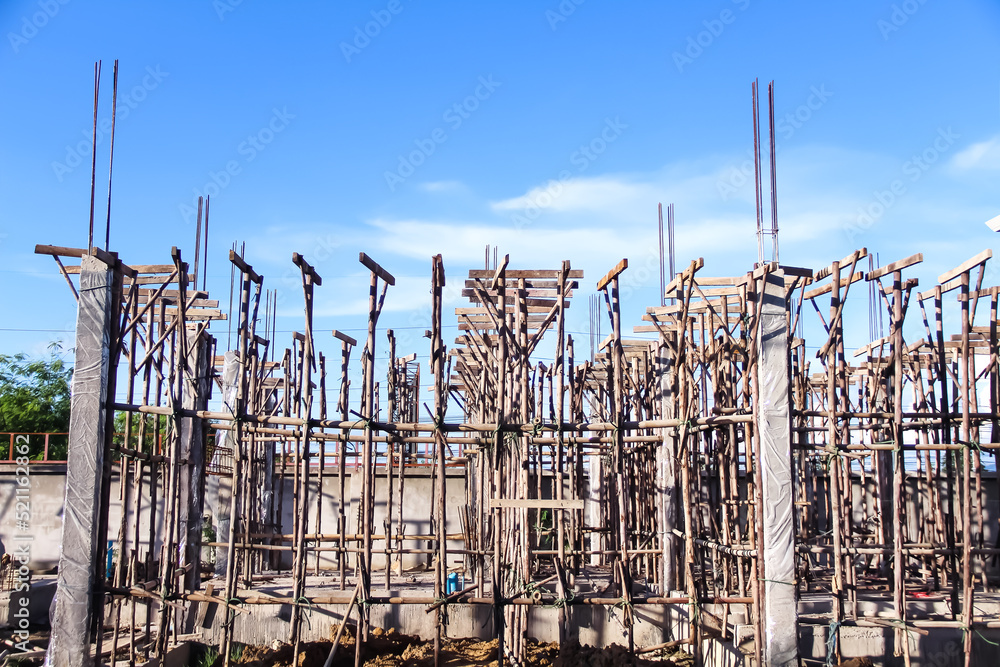 Construction site background with wood home structure and concrete pole ...