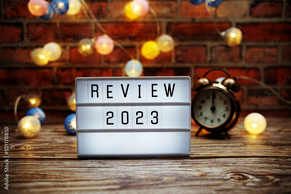 Review 2023 text in light box with alarm clock and LED cotton balls ...