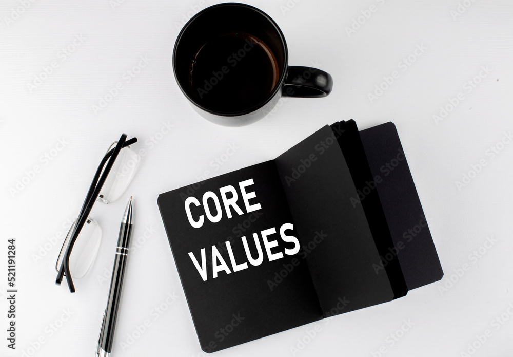 CORE VALUES written text in small black notebook with coffee , pen and ...