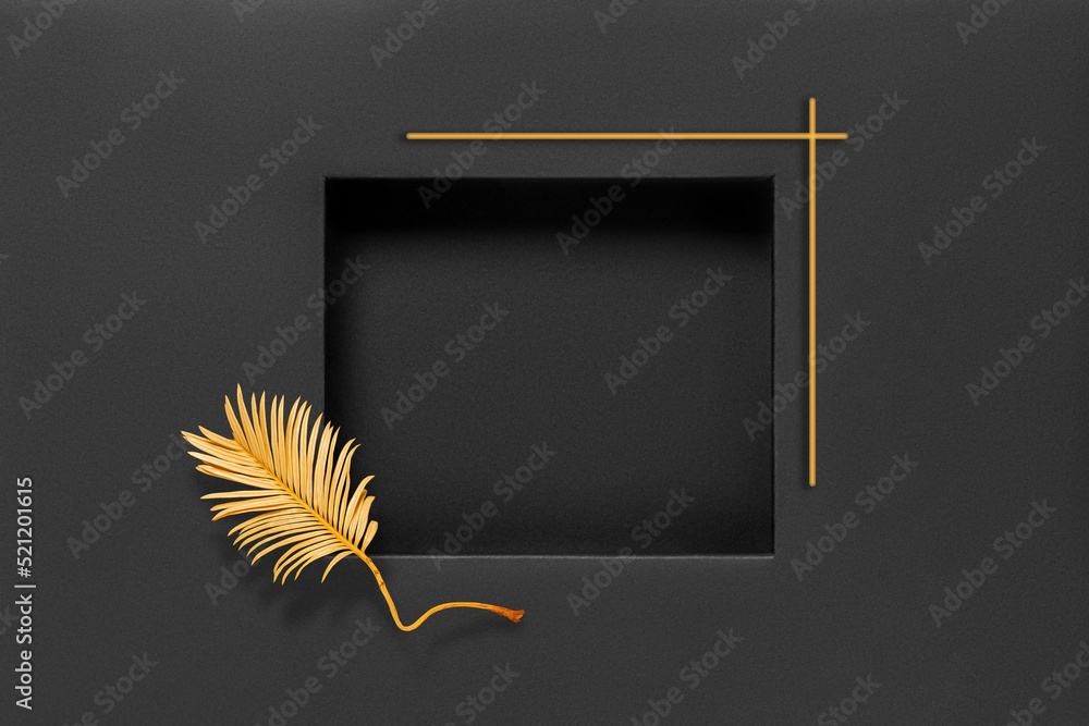 Recessed black paper frame decorated with dry yellow palm shape leaf ...