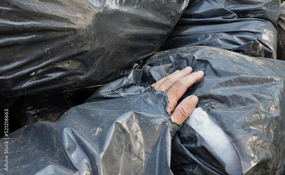 dead man in a black plastic garbage bag. bags for the dead from which a ...