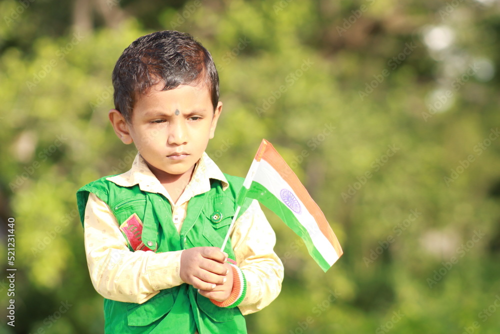 little indian boy proudly holding Indian National flag. The national ...