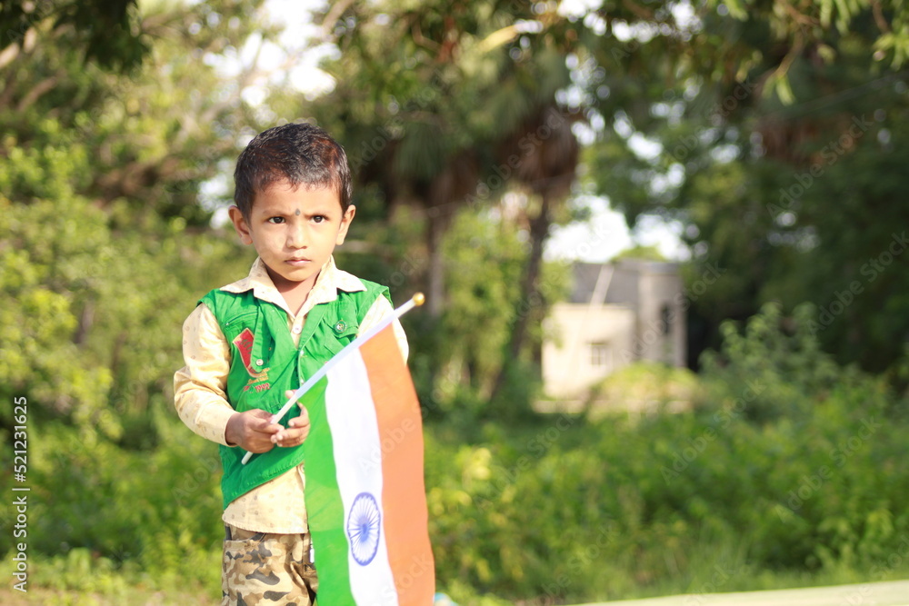 little indian boy proudly holding Indian National flag. The national ...