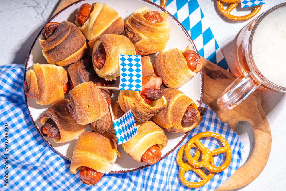 Oktoberfest party food. Pretzel hot dogs, puff pastry rolls with ...