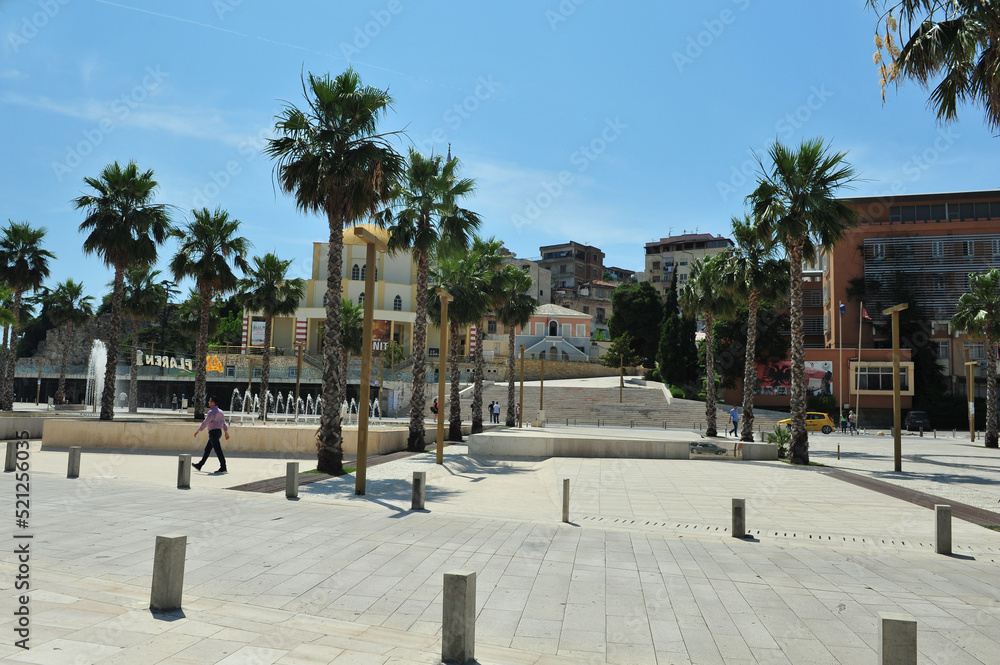 Street view from a town square in Durrës, Albania. People walking and ...