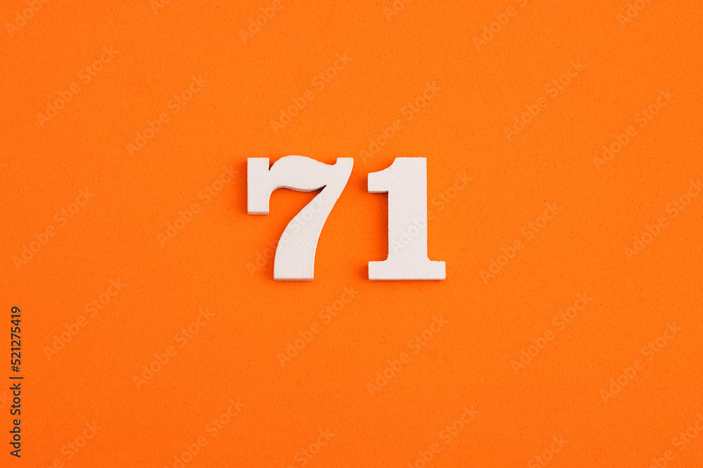 White wooden number 71 on eva rubber orange background Stock Photo ...