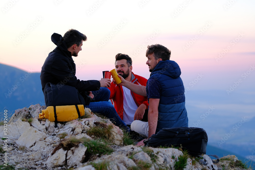 A Group of happy tourists is resting while drinking a cup of coffee ...