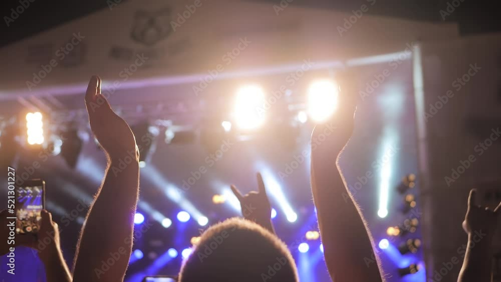 Slow motion: man silhouette partying, cheering, raising hands up and ...