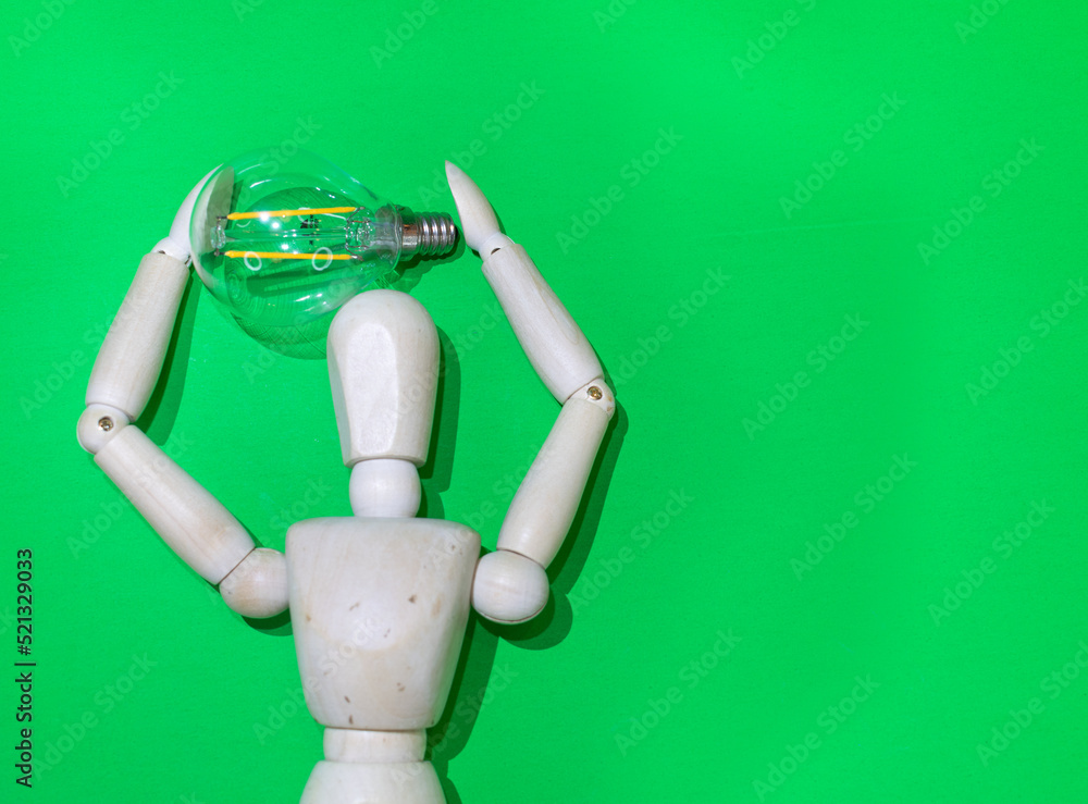 Mannequin Wood Figure carrying an incandescent light bulb. New idea ...