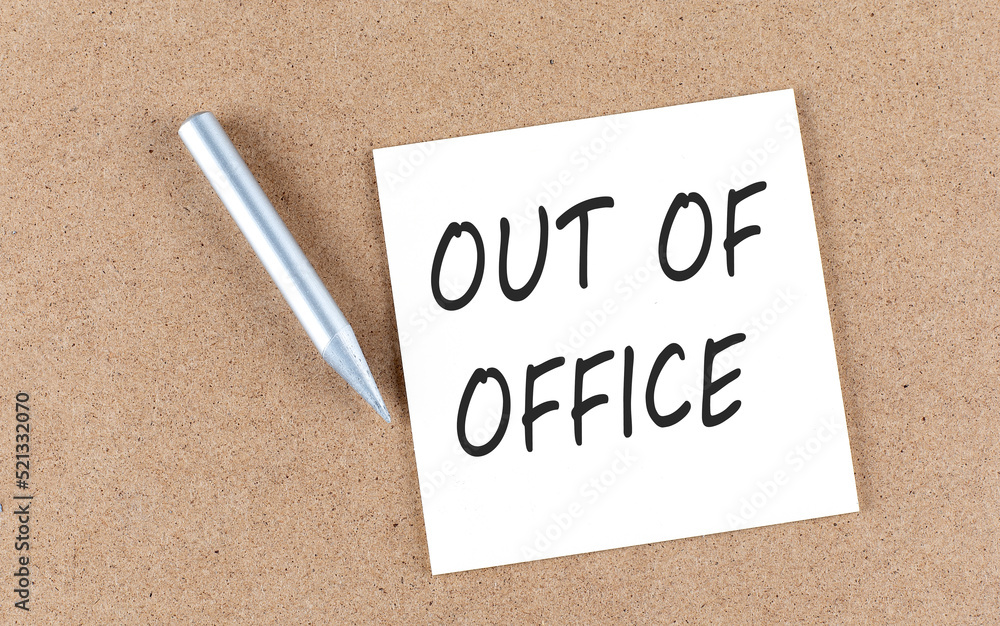OUT OF OFFICE text on sticky note on a cork board with pencil , Stock ...