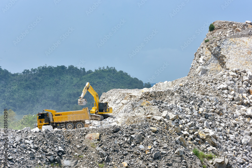 Excavator dig ground at construction site. Earthmover on road ...