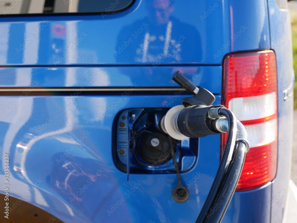 Compressed natural gas (CNG) vehicle fuel nozzle connected to car Stock ...