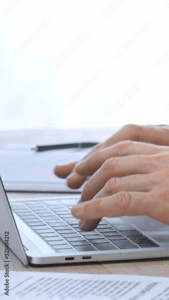 vertical video of cropped businessman typing on laptop keyboard Stock ...