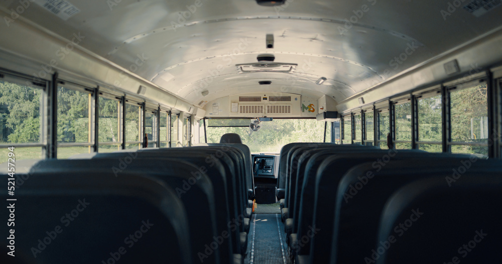 Interior empty school bus closeup. Rows seats inside safety public ...