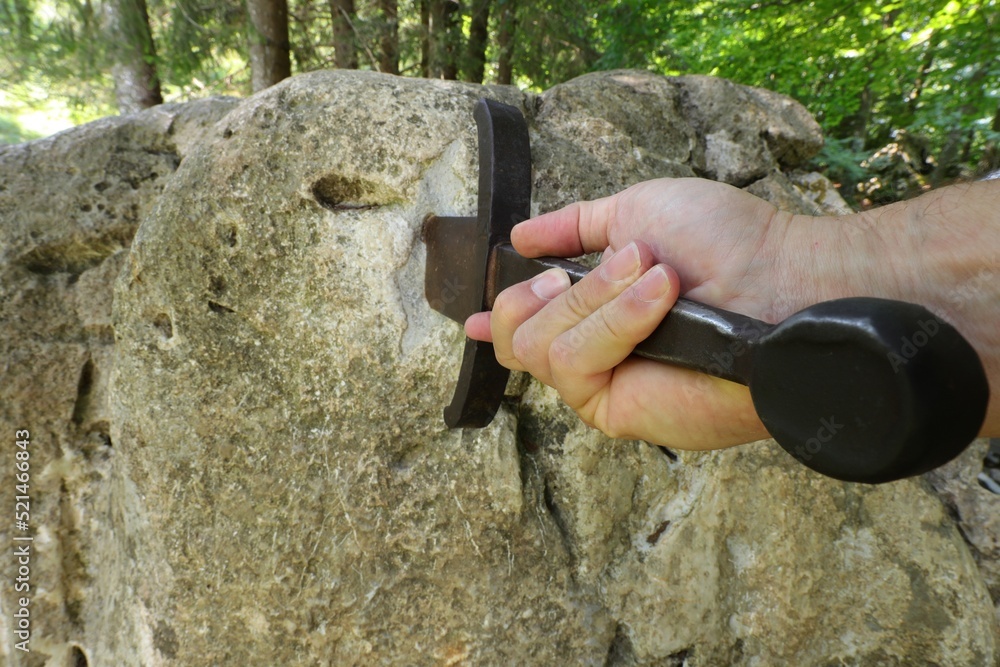 hand and sword in the stone as in the legend of King Arthur Stock Photo ...