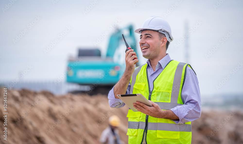 Surveyor engineer wearing safety uniform ,helmet and radio ...