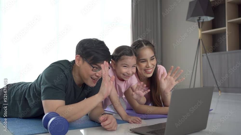 Asian family, father mother and daughter making an online live ...