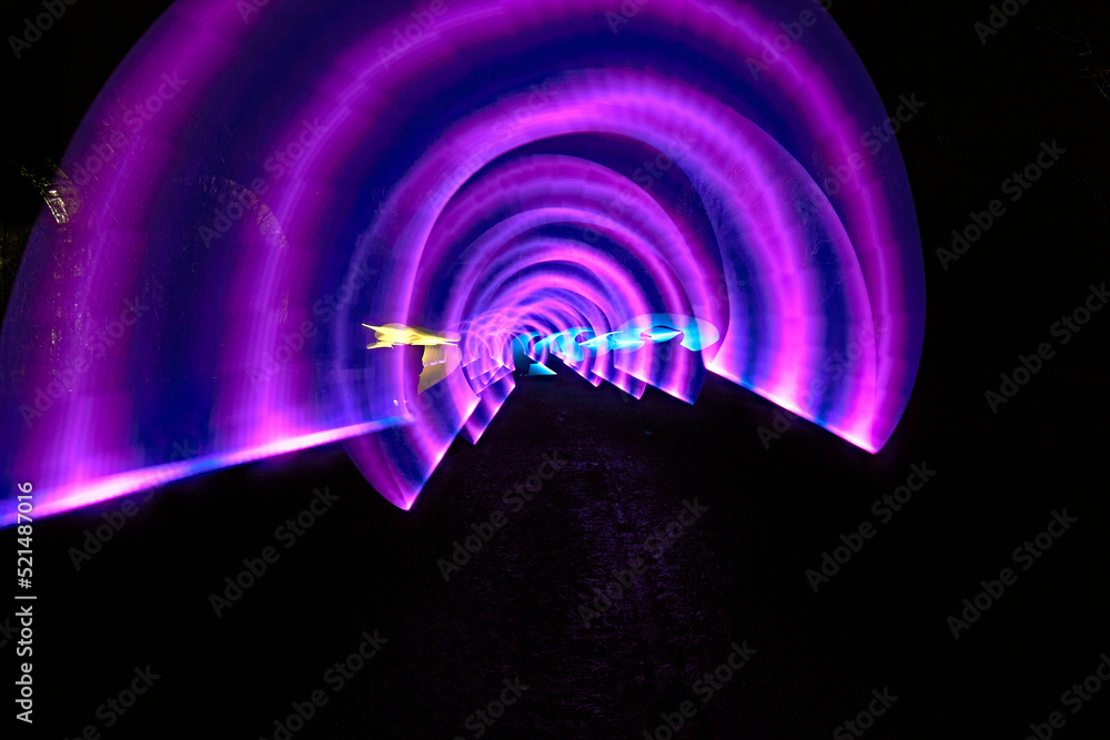 Pink, purple glowing shiny tunnel of light trails effect with yellow ...