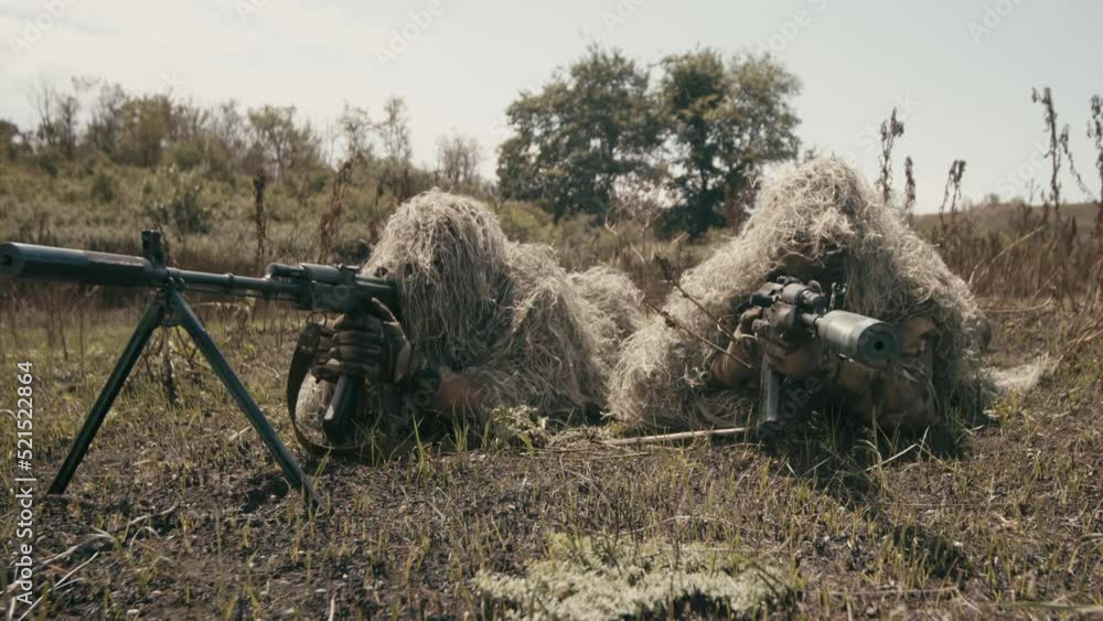 Vídeo do Stock: Snipers in an ambush in the grass, disguised as terrain ...