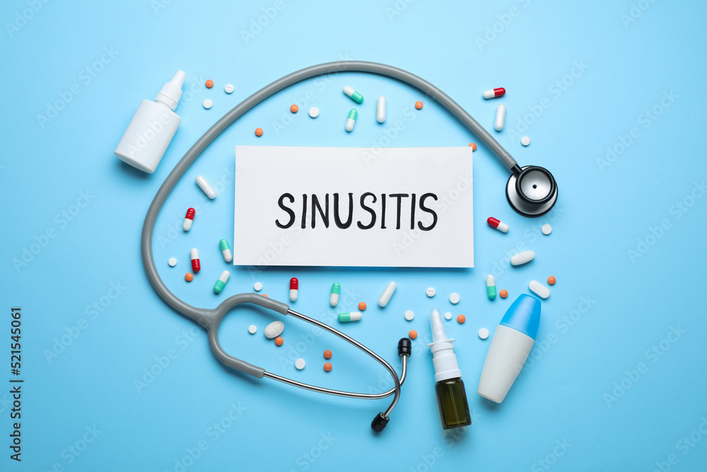 Card with word SINUSITIS, stethoscope and different drugs on light blue ...