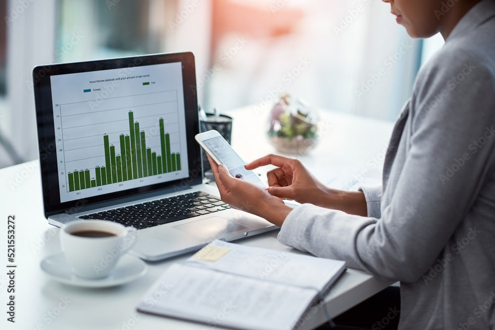 Female data analyst or finance manager working on phone in a modern ...