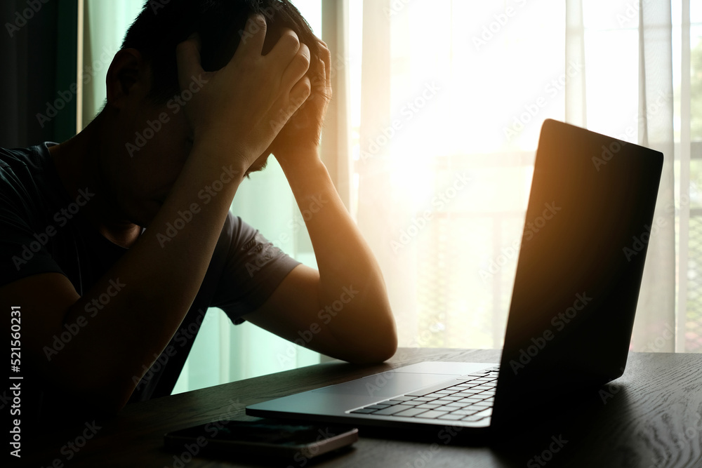 man sitting down, his face unsettled. At the computer desk he has ...