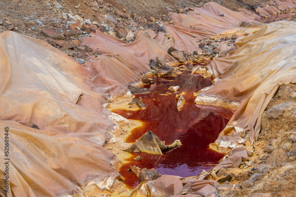 Red polluted toxic water in copper mine. Mining of ores of various ...