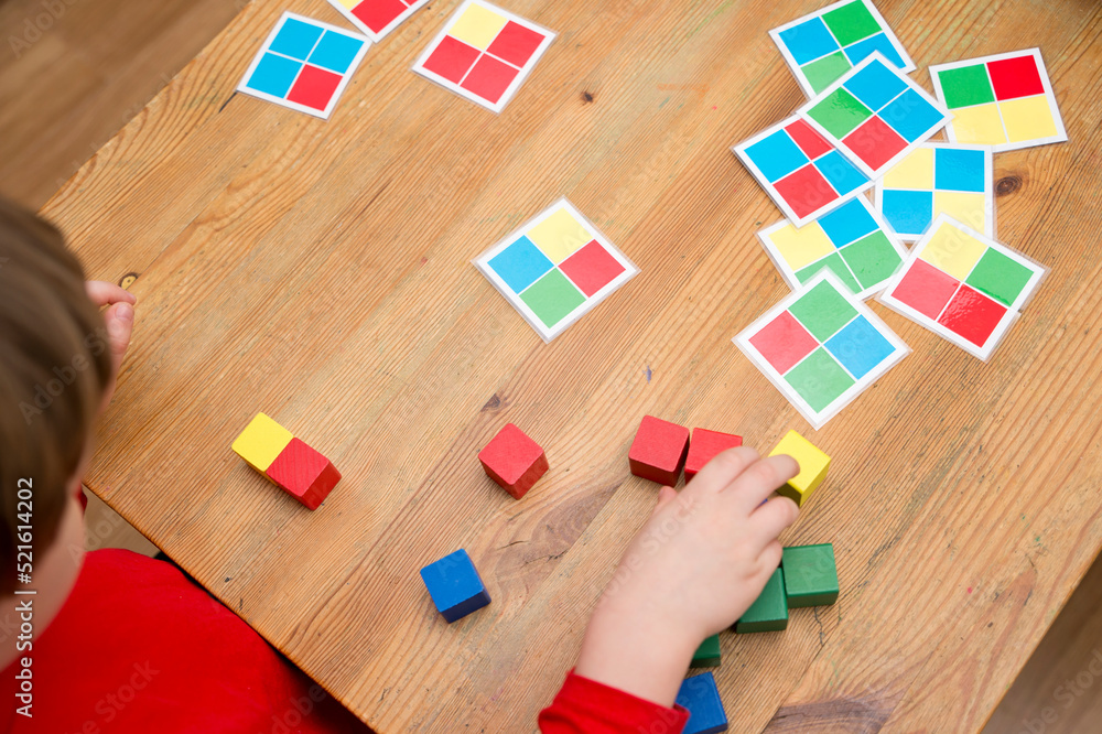 Kid playing logical game. Repeat the sequence. Color squares on ...