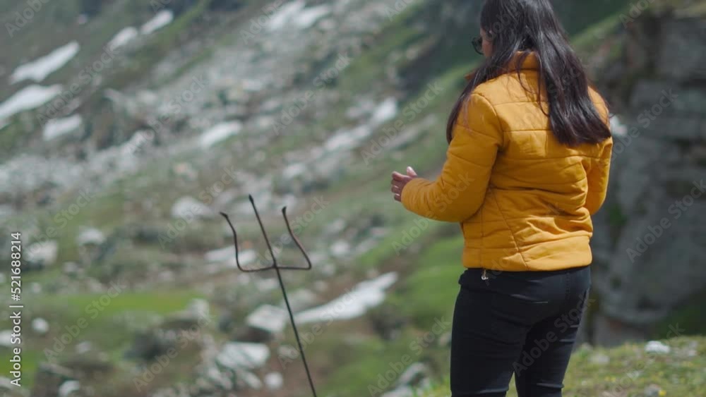 Portrait of Indian female traveler praying at Trishul of Shiva in ...