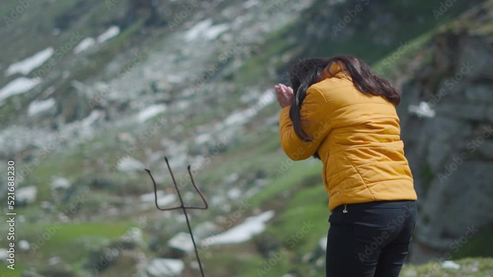 Portrait of Indian female traveler praying at Trishul of Shiva in ...