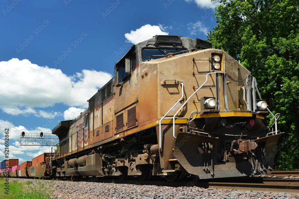 Diesel locomotive pulling a freight train of container cars Stock Photo ...