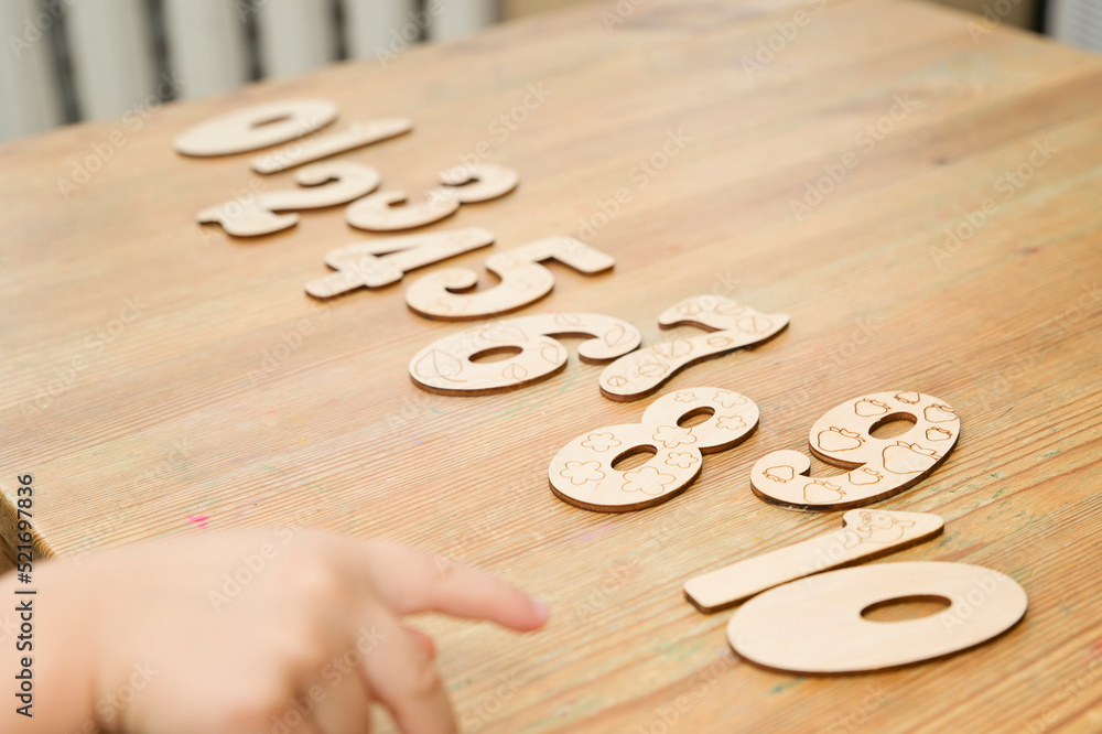 Wooden jigsaw digits from 0 to 10 on natural wood table. Learning ...