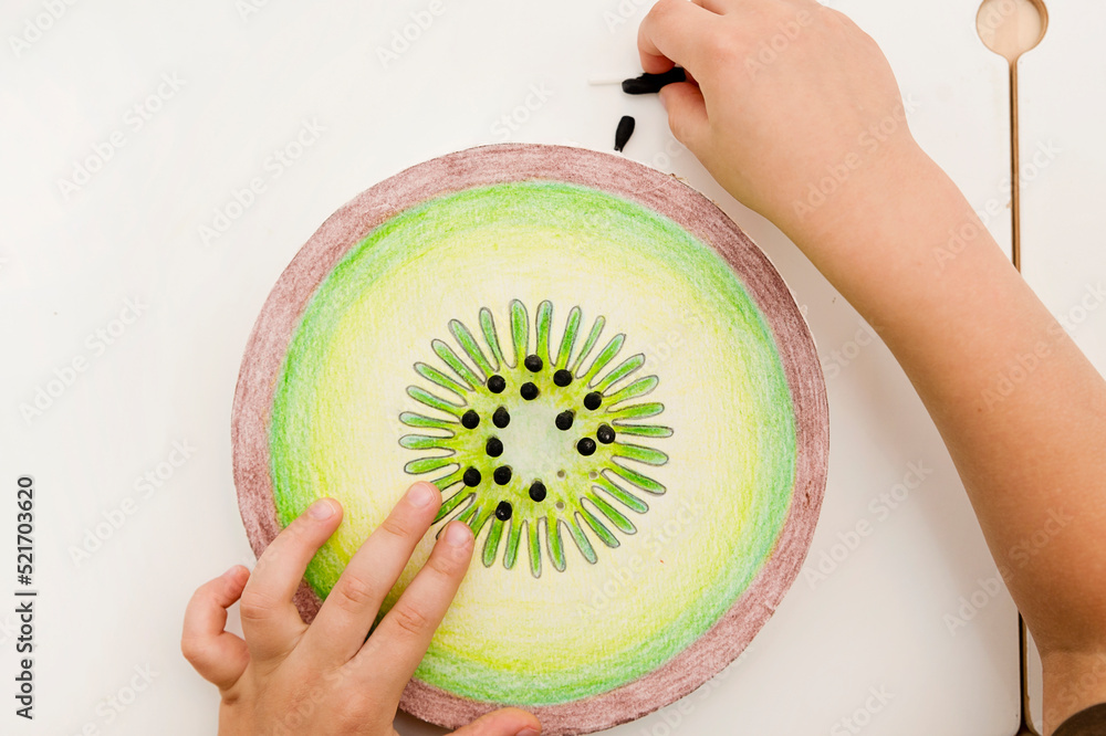 Slice of Kiwi fruit. DIY home made paper toy. Seeds made of black ...