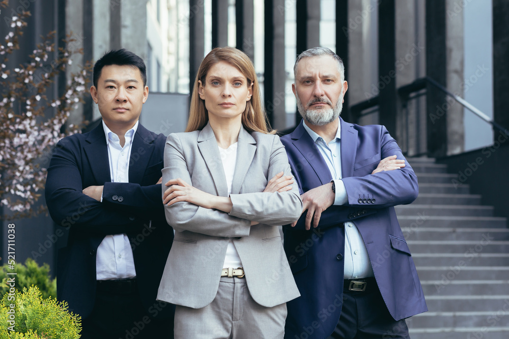 Serious and confident female boss with team of workers, group of ...