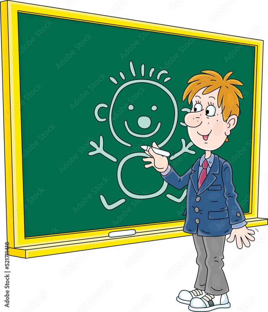 Schoolboy drawing a funny picture with chalk on a blackboard in a ...