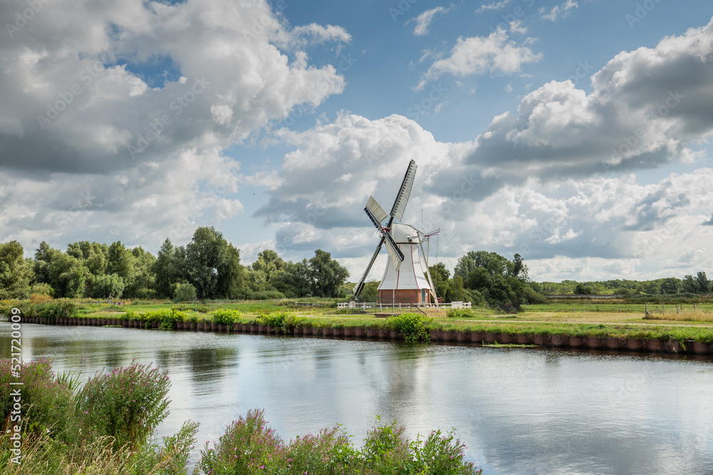 Polder landscape with canal and Witte Molen in Haren Glimmen in the ...