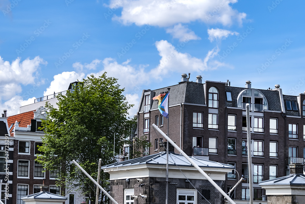 Celebration of pride month in Amsterdam: Rainbow flag hanging outside a ...