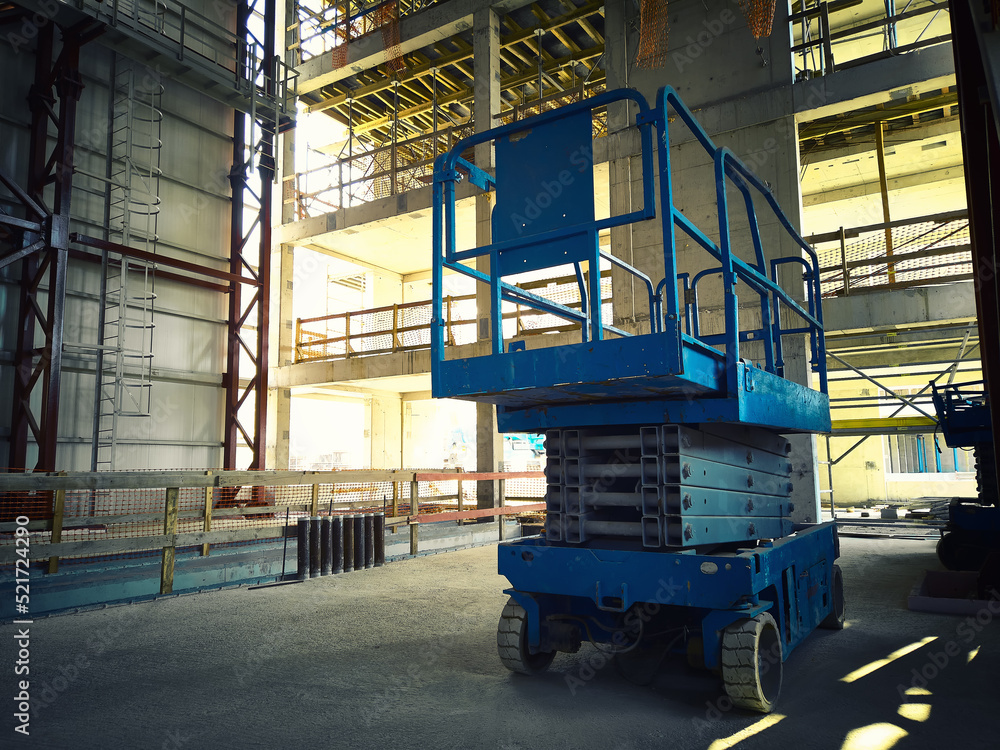 Hydraulic lifting platform at construction site. Scissor lift platform ...