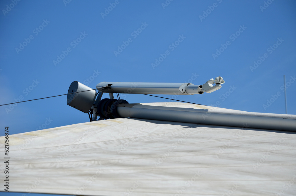 parasol, awning, folding tarpaulin against the sun is rolled up into a ...