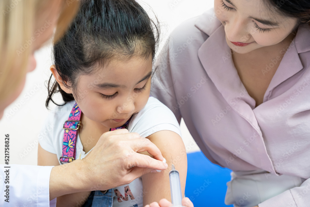 Young Asian girl get medical vaccination from the doctor with her ...