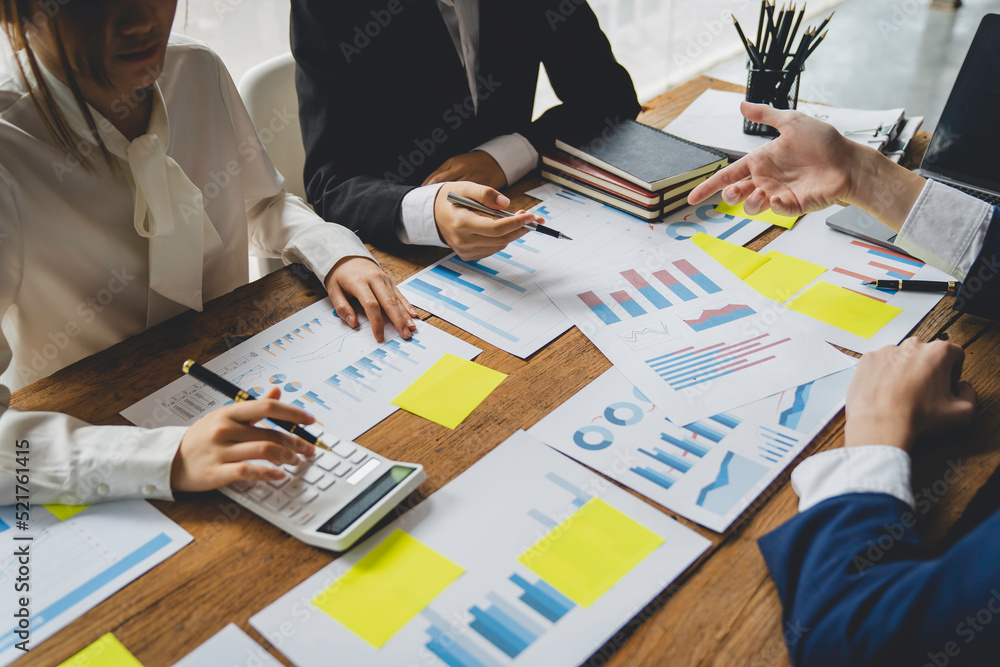 Teamwork with business people analysis cost graph on the desk in the ...