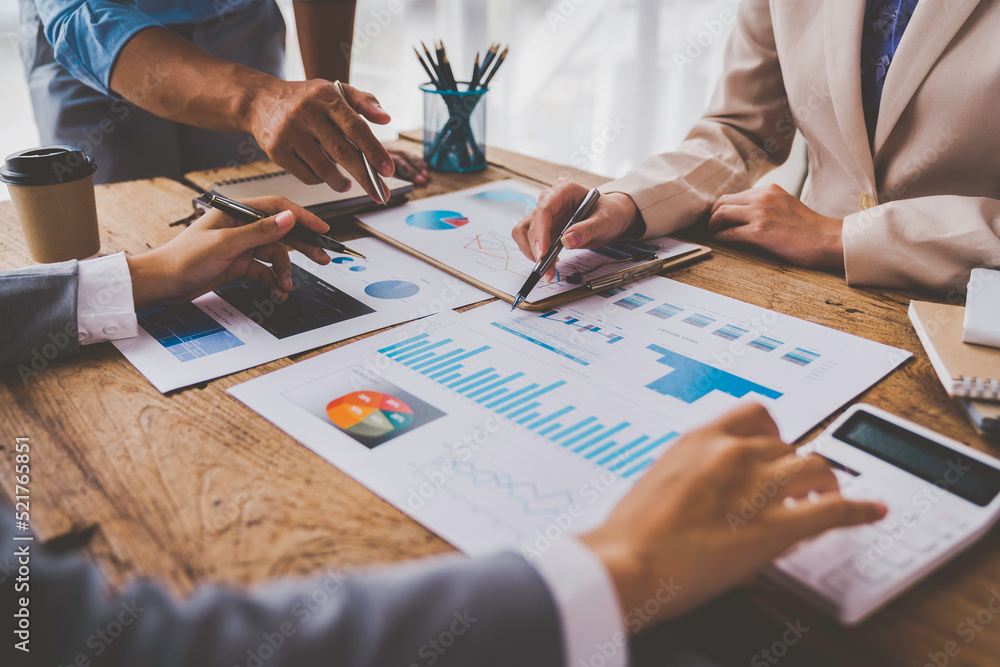 Financial analyst analyzes business finance reports on laptop and graph ...