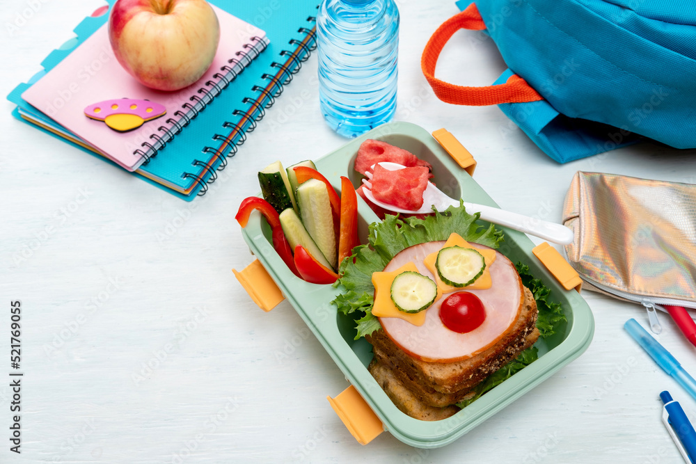 School lunch box for kids with food in the form of funny faces. School ...