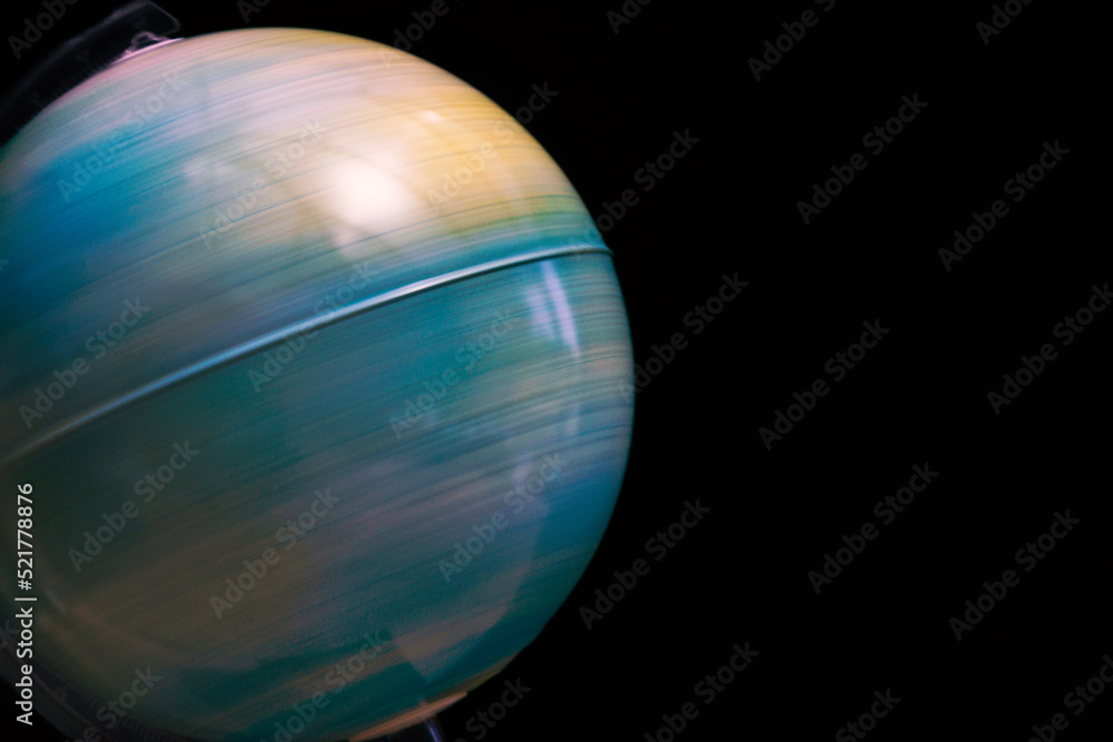 Slow shutter speed image of a world globe spinning creating a blurred ...