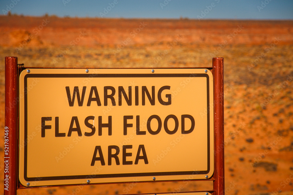 A warning sign for flash floods in a dry riverbed near Antelope Canyon ...